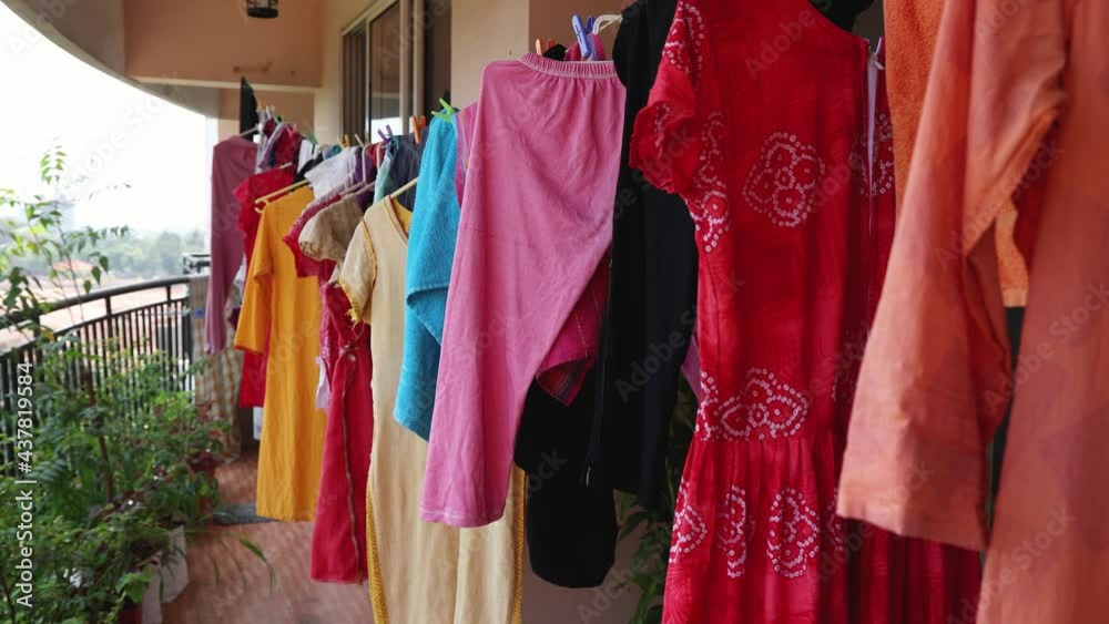 Video Stock Hanging clothes on washing line for drying in balcony of ...