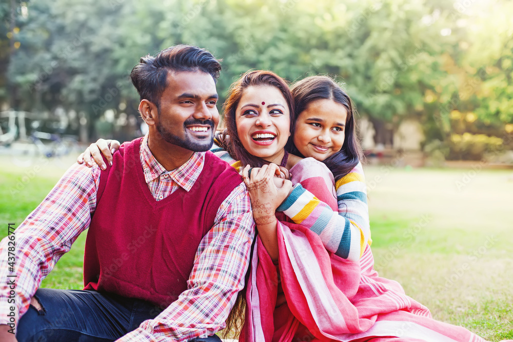 Beautiful Indian family hugging each other during the picnic in the ...