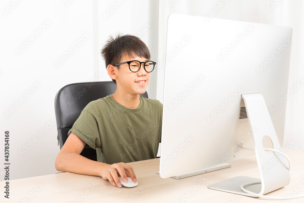 Young Asian preteen boy using computer at home for podcast, gaming ...