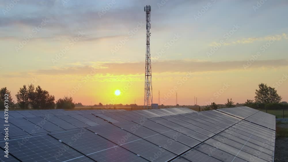 5G telecom tower and solar panel farm at sunset, future technology ...