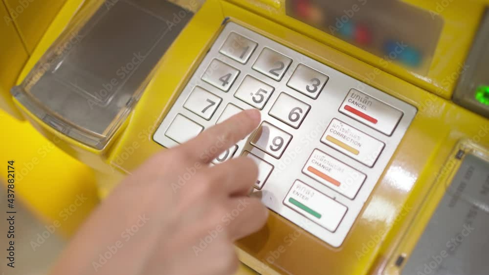 Side view of caucasian woman hand entering put the passcode on the ATM ...