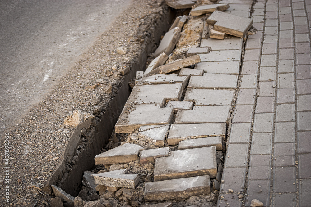 Street sidewalk damaged pavement with trench along. Street repair works ...