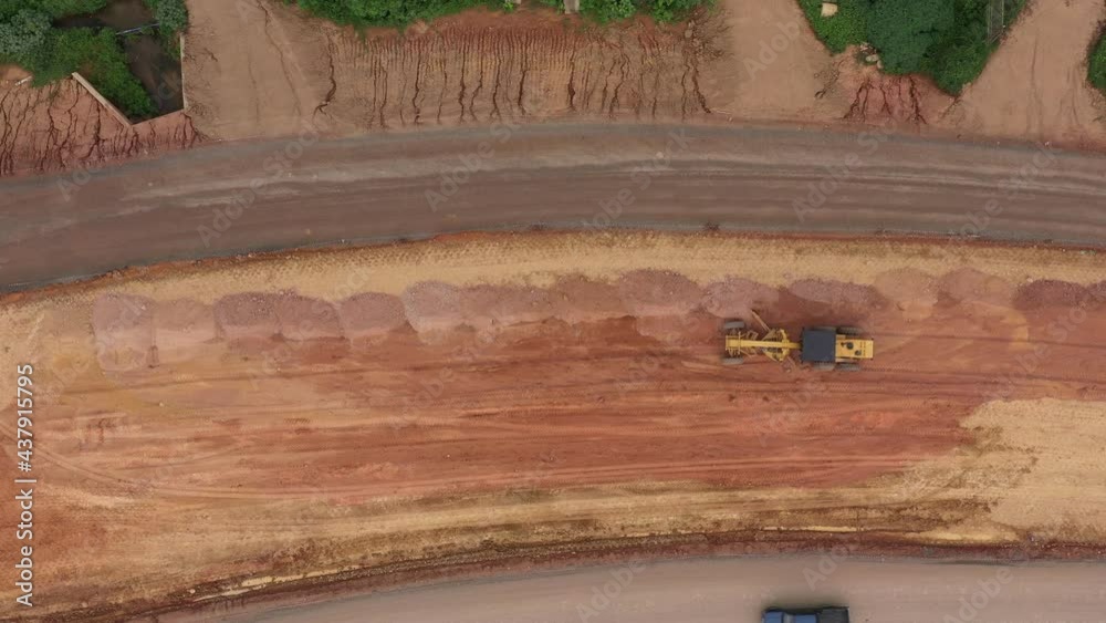 Aerial view of heavy machinery a road grader, motor grader, working in ...