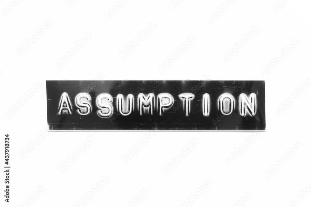 Embossed letter with word assumption in black banner on white paper ...