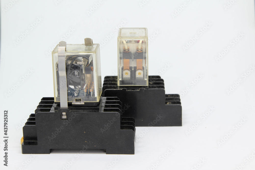 The electrical auxiliary relay in transparent plastic cases on white ...