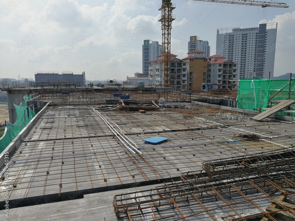 Slab formwork and reinforcement bars in a construction site with crane ...