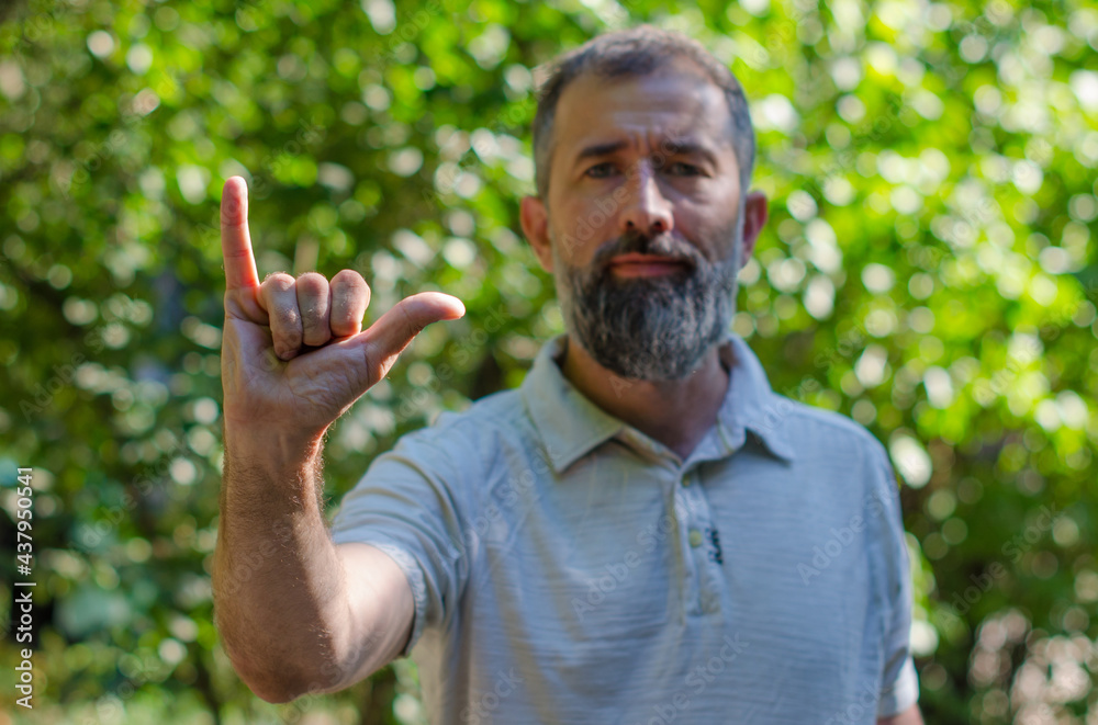 Cropped image of a man in casual clothes show hand sign "Y". Body ...