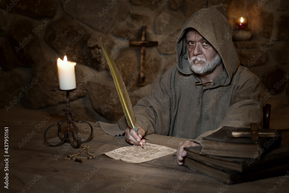 Old monk writes an old letter in the Middle Ages Stock Photo | Adobe Stock