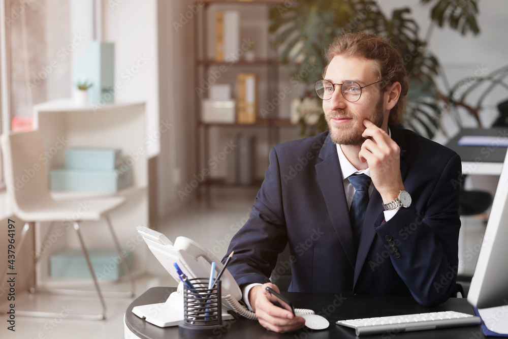 Handsome young man working in office Stock Photo | Adobe Stock