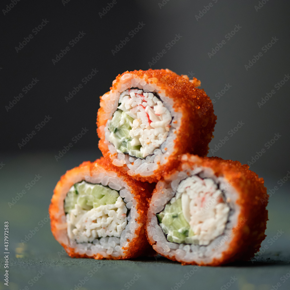 Inside-out Sushi Set. Pyramid of three sushi. Rolls in masago or tobiko ...