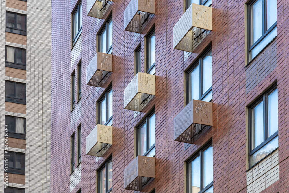 The facade of a new high-rise building with windows and compartments ...