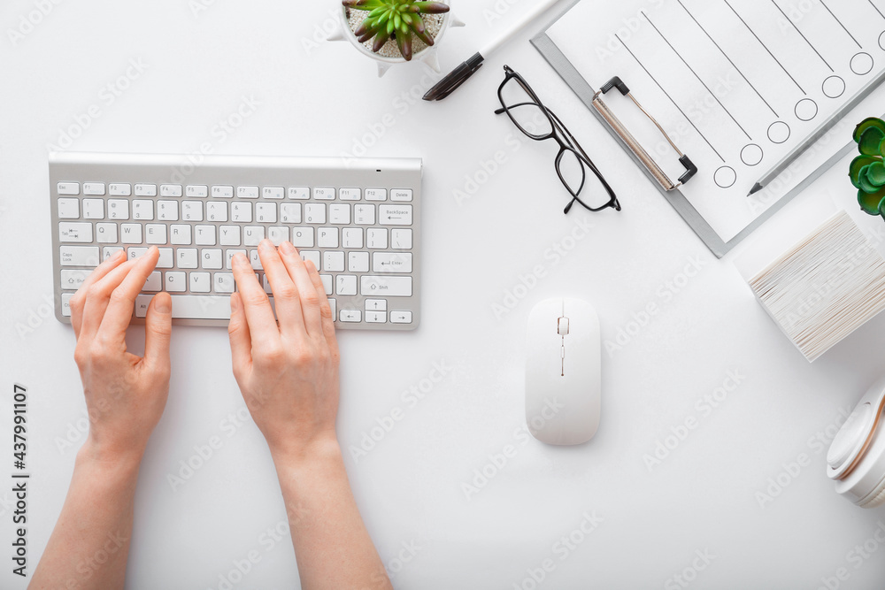 Female hands typing on keyboard at white table workplace. Home office ...