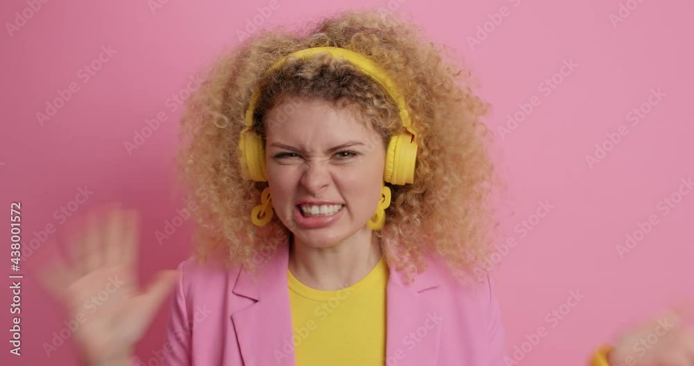 Angry outraged woman raises hands screams with annoyed expression has ...