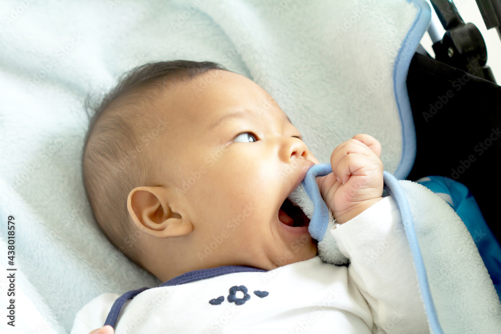 newborn boy putting fingers on mouth touching gums because toothache at ...