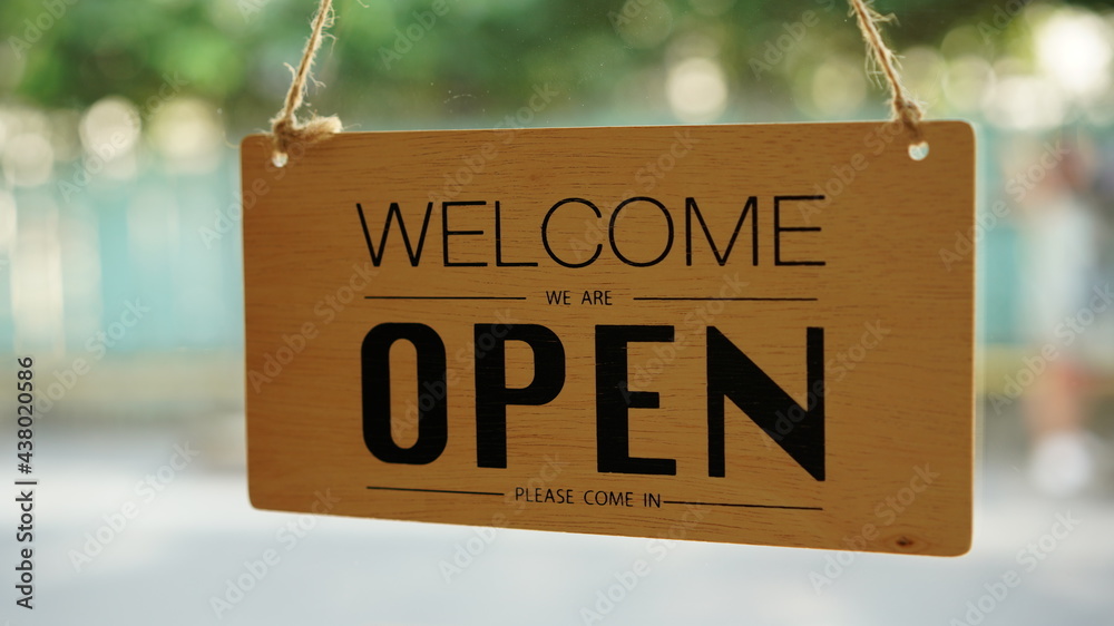 Open and closed sign in front of coffee shop and restaurant glass door ...