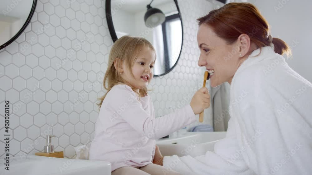 Daughter tooth brushing mothers teeth in the morning. Stock Video ...