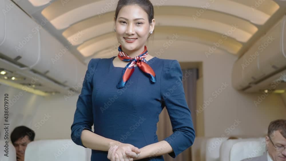 Beautiful flight attendant standing waiting for the passengers to board ...