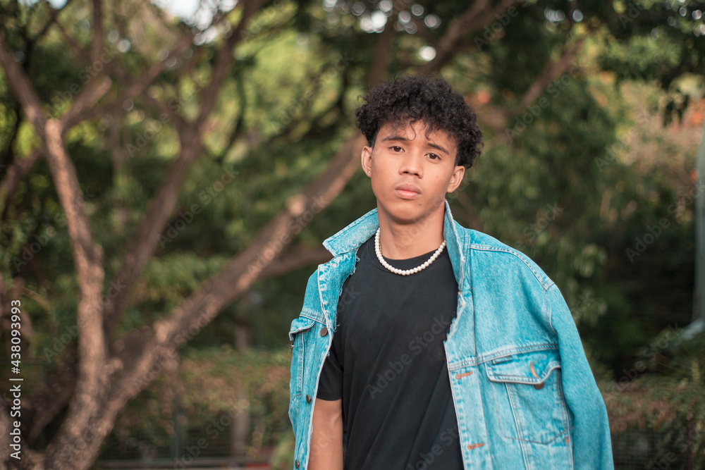 A young Filipino-African man. Handsome biracial young man outdoors. In ...