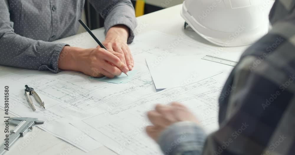 Architects work at a desk with sketches, drawings. Construction ...