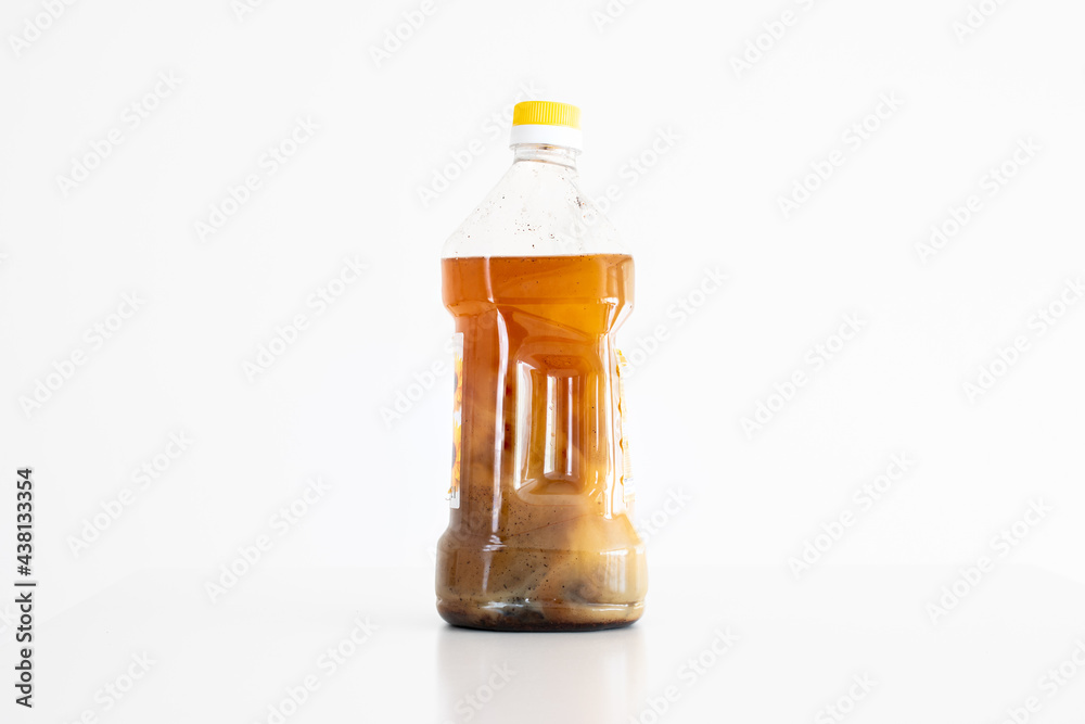 Used spent sunflower cooking oil in a plastic bottle. Burnt fried foot ...