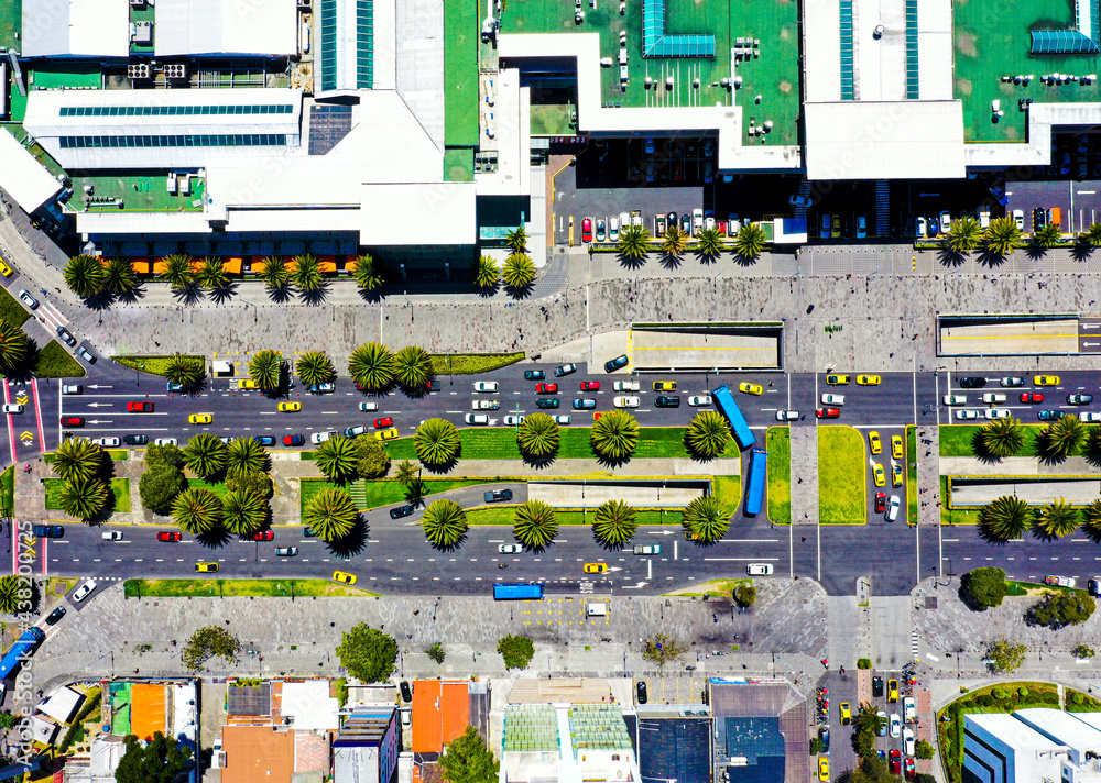 Aerial top view a four lane street with a separate bus entrance full of ...