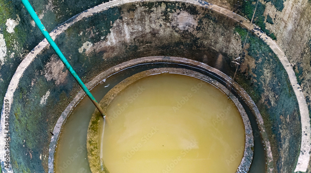 Old damaged well with two concrete cement rings to purify undrinkable ...