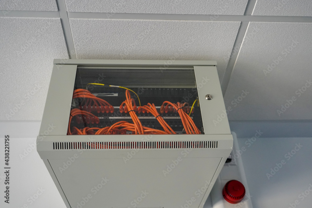 Network switch enclosure high up on a ceiling in a office Stock Photo ...