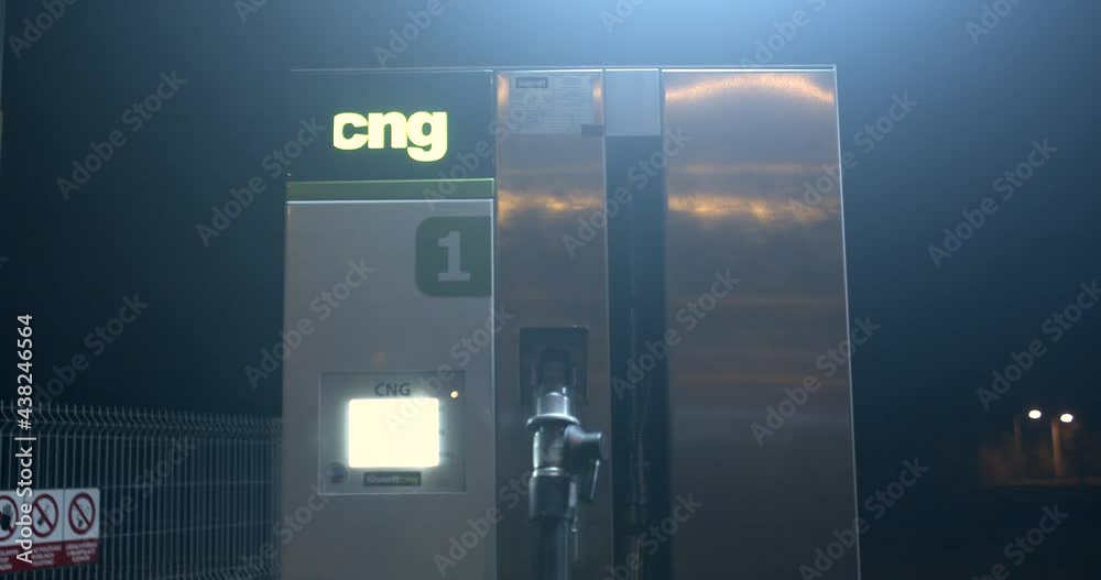 Refueling terminal CNG symbol at gas station night. Attracting the ...