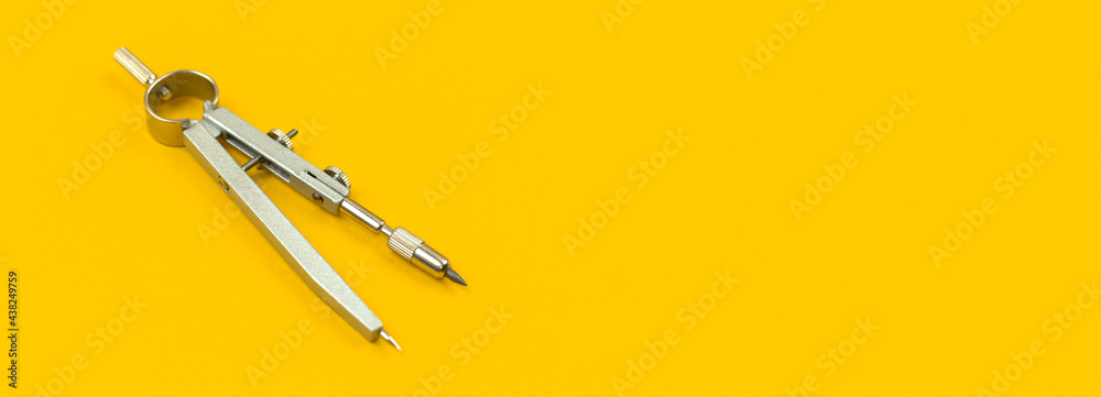 School geometry concept banner with drawing compass on a office table ...