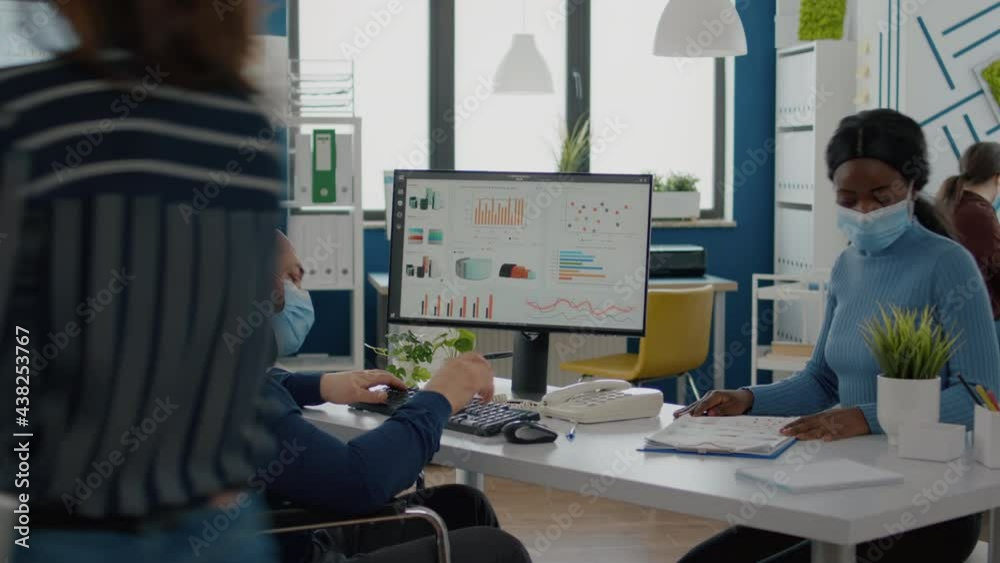 Video Stock Diverse colleagues with masks respecting social distance ...