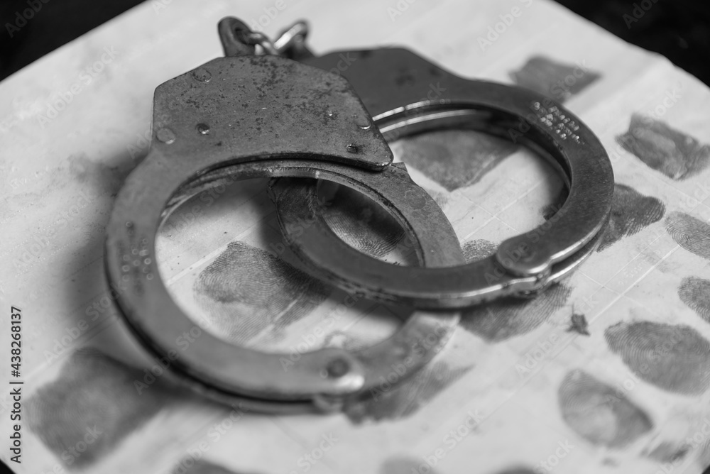 Foto de Crime and violence concept.Police Handcuffs on fingerprints ...