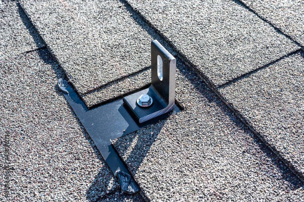 Residential asphalt shingle roof with metal anchors installed for the ...