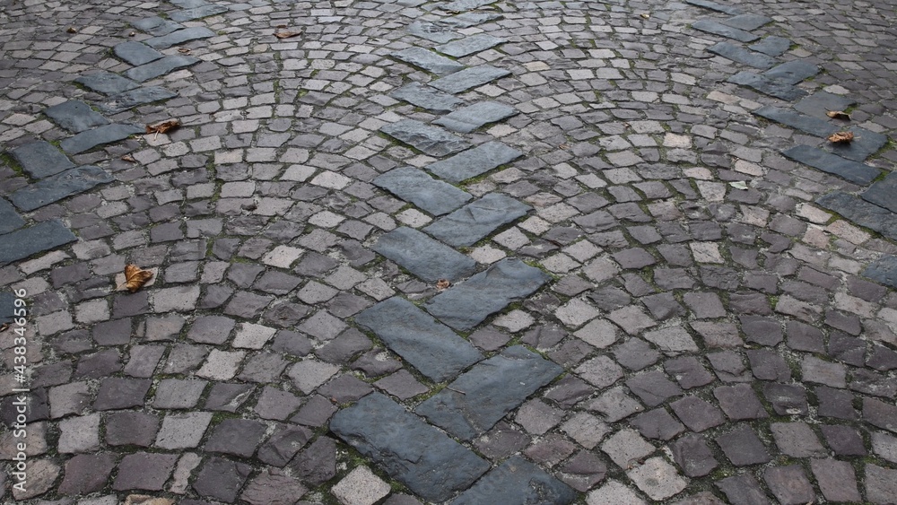 Ancient stone paving road in old town. Cobblestone pavement with ...