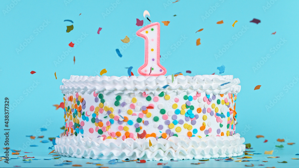 Colorful tasty birthday cake with candles shaped like the number 1 ...