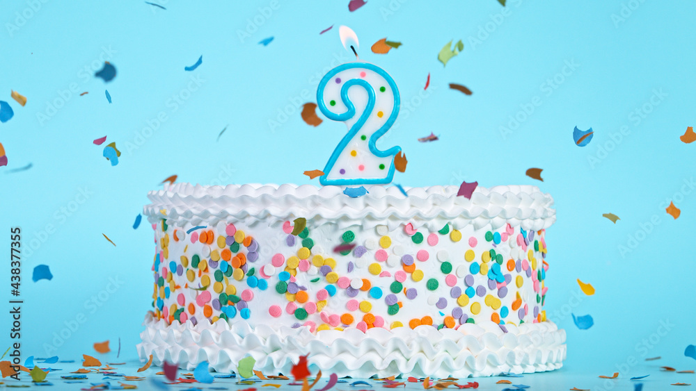 Colorful tasty birthday cake with candles shaped like the number 2 ...