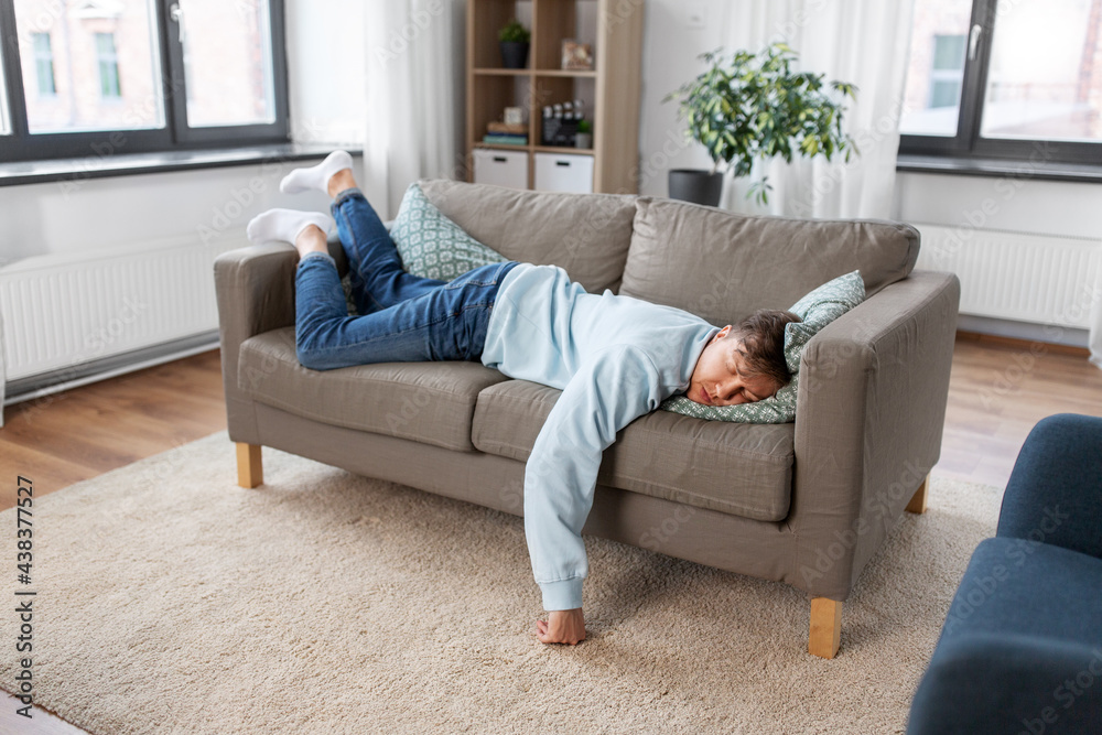 people, boredom and depression concept - lazy young man sleeping on ...