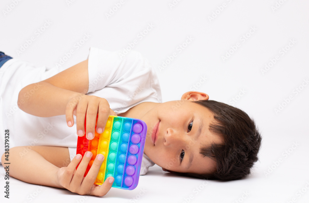 Child plays with sensory fidget toy Pop-it. Instrument for fine motoric ...