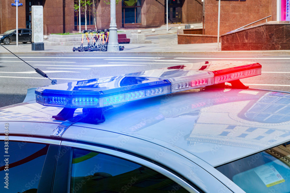 Red and blue flashing lights on police car. Stock Photo | Adobe Stock