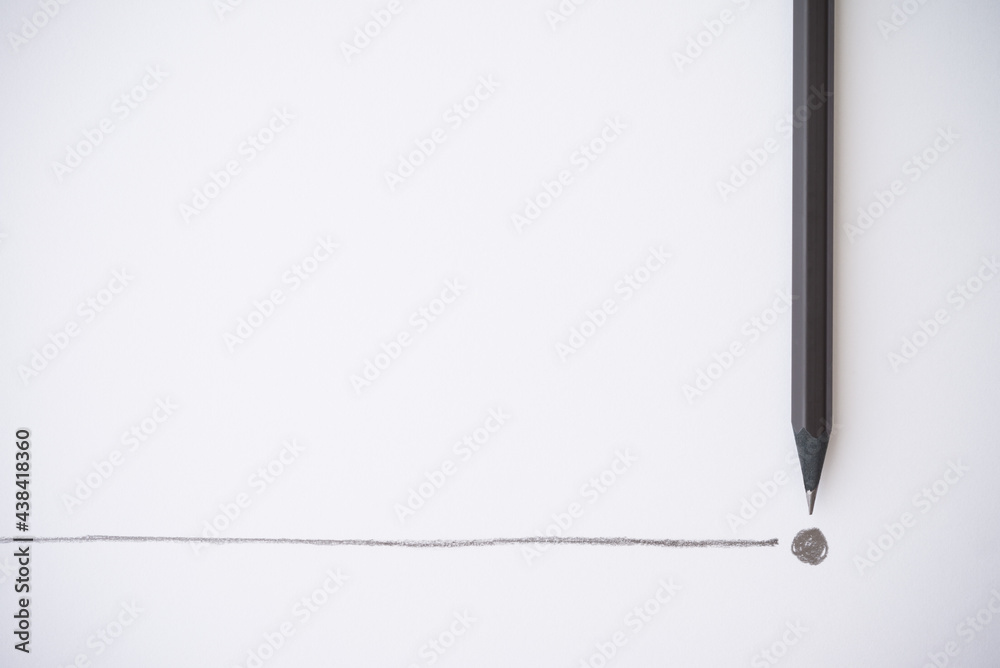 Flat lay of black colour pencil write line and end point on white paper ...