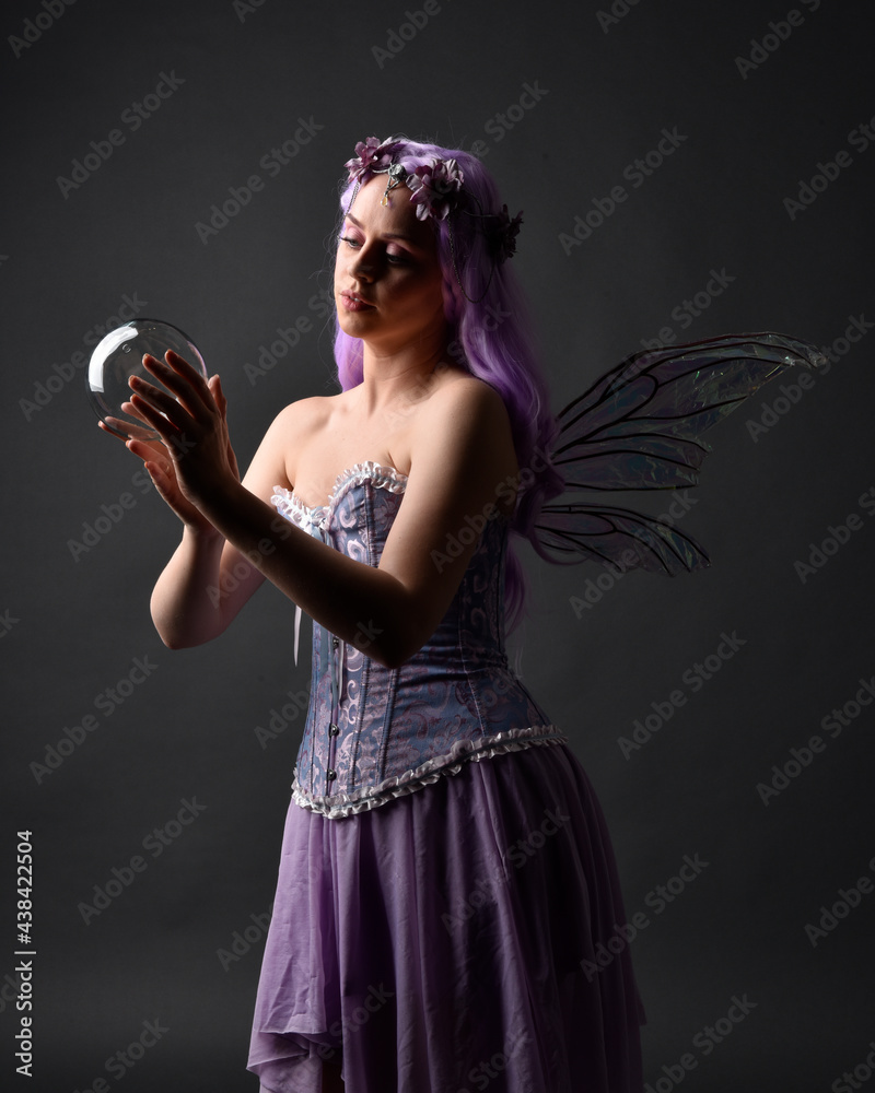 Close up portrait of a purple haired girl wearing fantasy corset dress ...