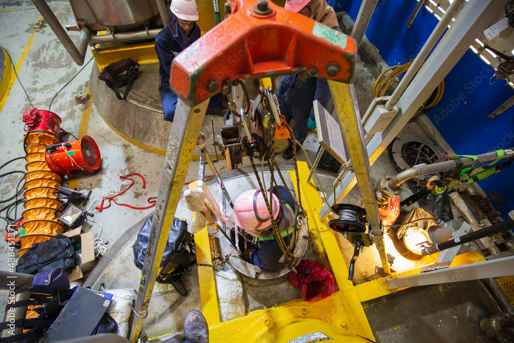 Top view male climb up the stairs into the tank stainless chemical area ...