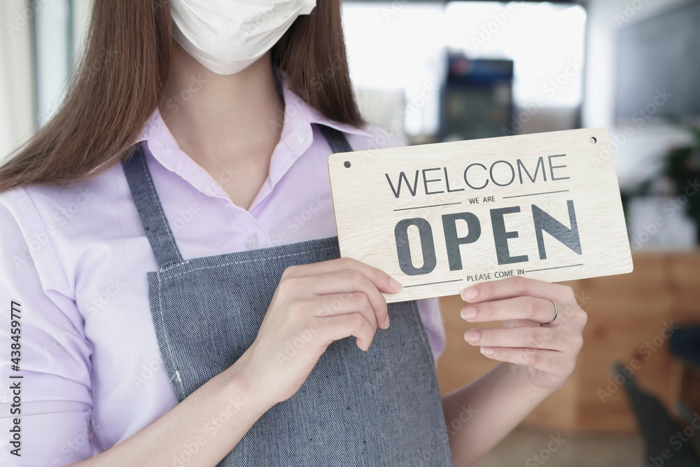 Open. barista, Coffee shop owner with face mask turning open sign board ...