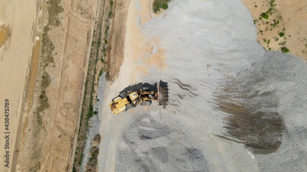 Wheel loader works in a gravel pit. Loading or unloading stone and ...