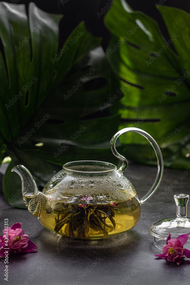Exotic green tea with flowers in glass teapot Stock Photo | Adobe Stock