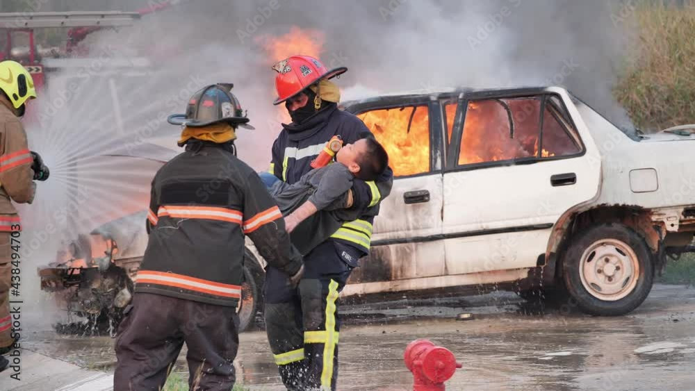 Asian fireman wear fire protection suit while saving a boy from a car ...