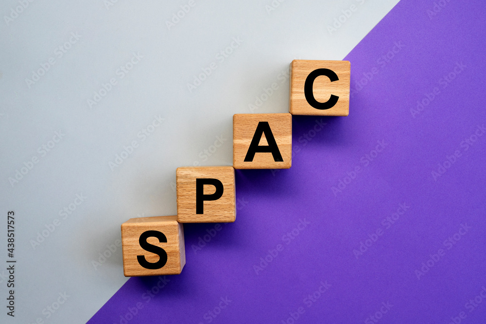 SPAC, special purpose acquisition company symbol. Wooden cubes with ...
