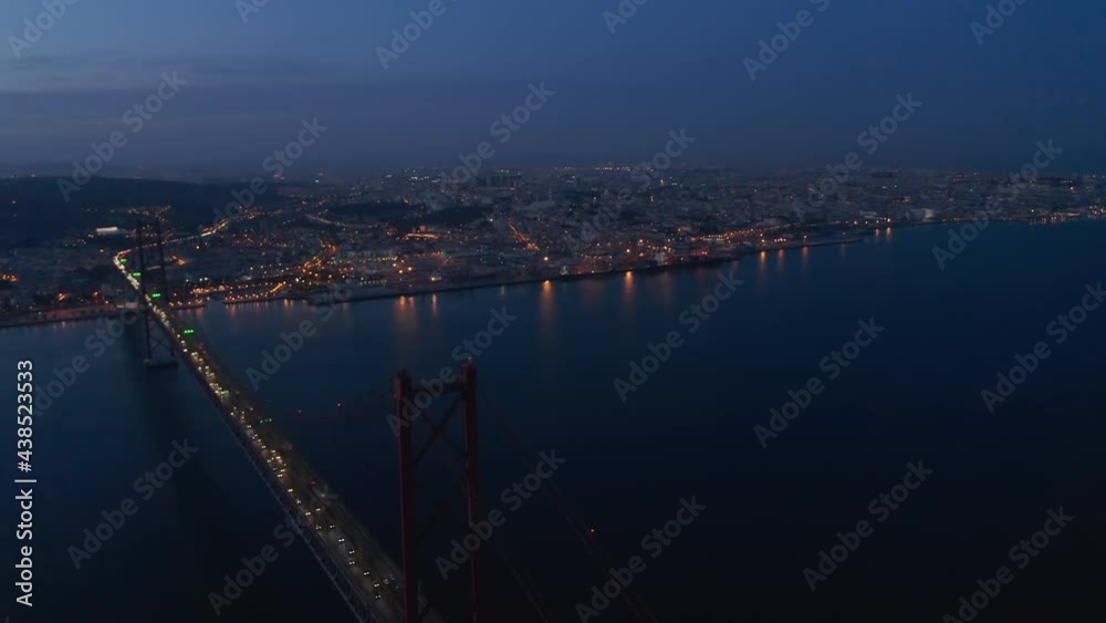 Night panoramic aerial view of town on rivershore. Light of cars ...