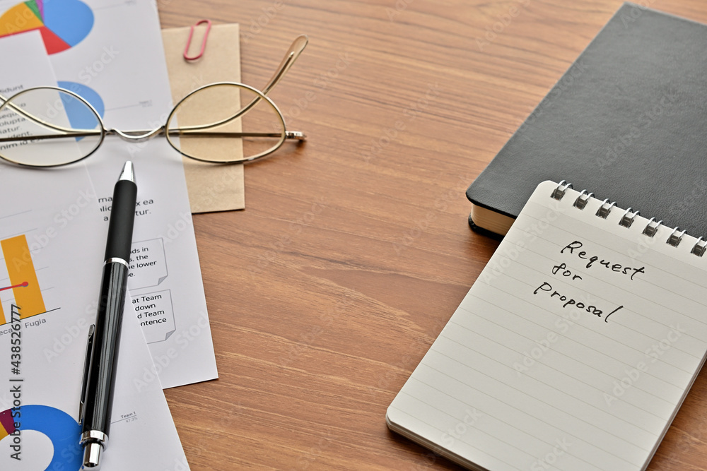 There is a note book with the word of Request For Proposal. It's on the ...