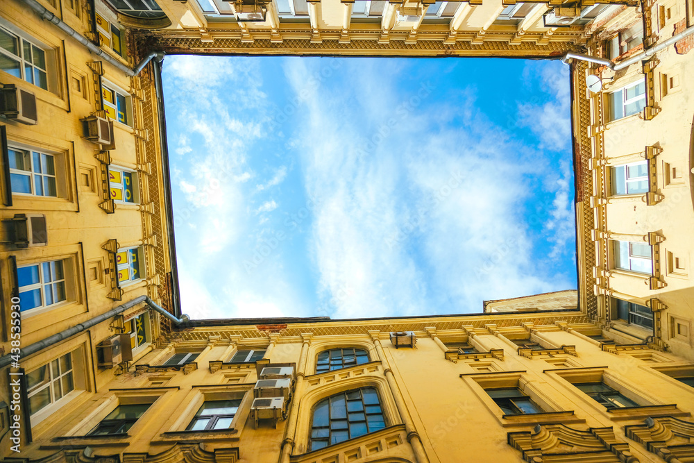 Courtyard-well. The yellow House is a bottom-up view of a blue sky with ...