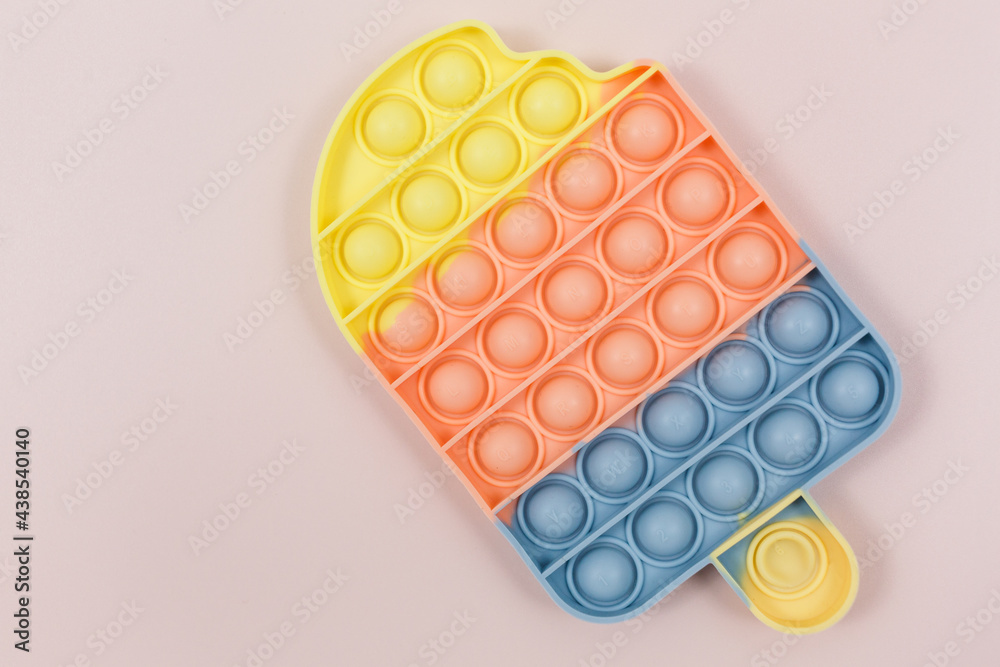 Popular silicone pastel anti-stress pop it toys for a child on pink ...